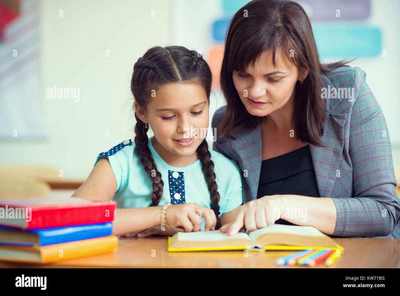 Yong beautiful teacher with schoolgirl school at klassroom Stock Photo ...