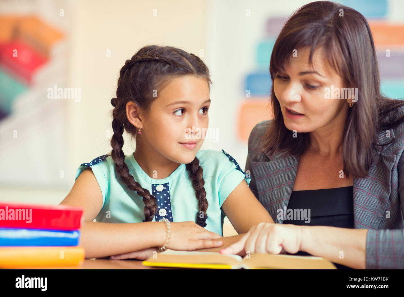 Yong beautiful teacher with schoolgirl school at klassroom Stock Photo ...