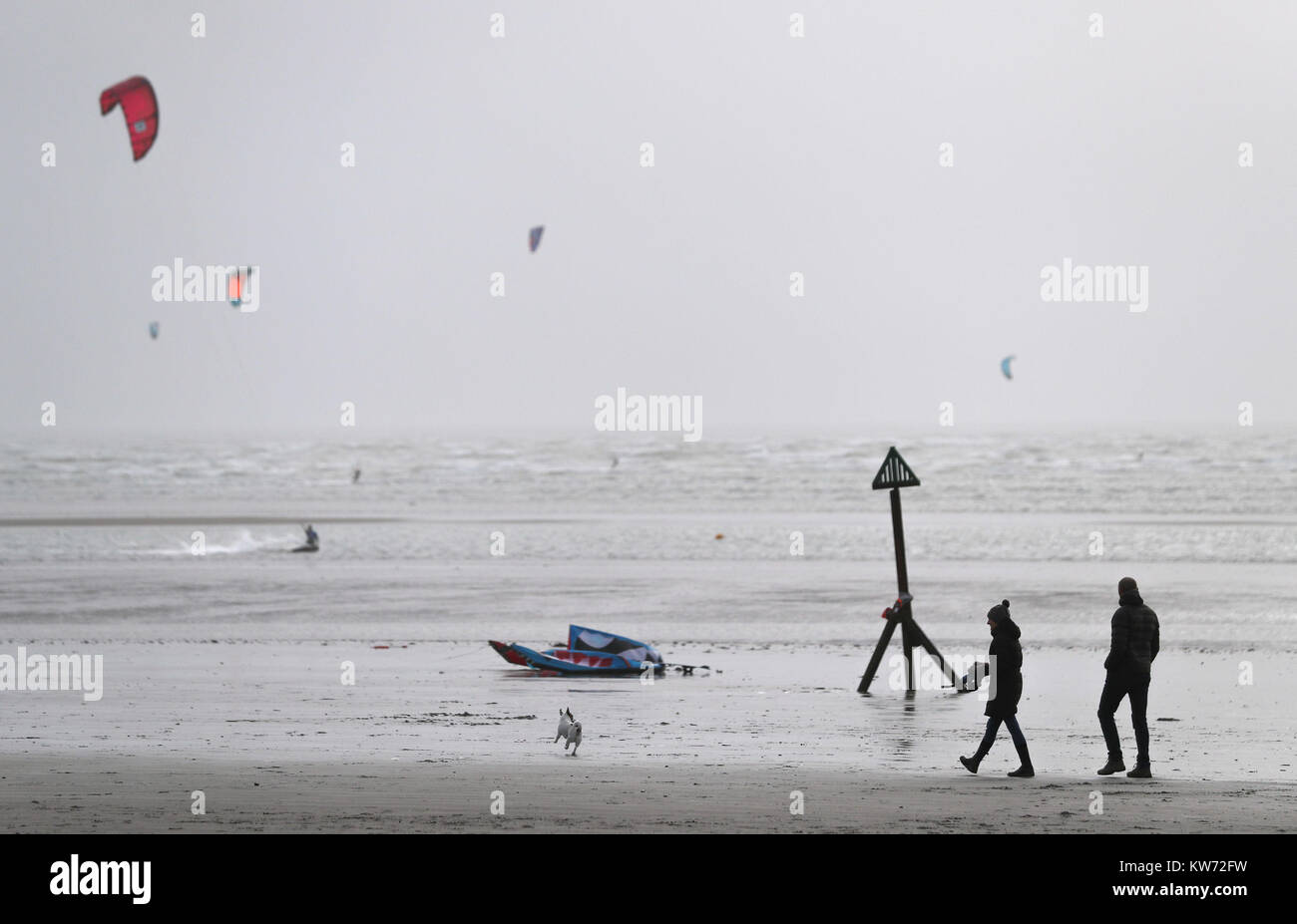 Kite surfers enjoy the strong winds on West Wittering beach in West ...