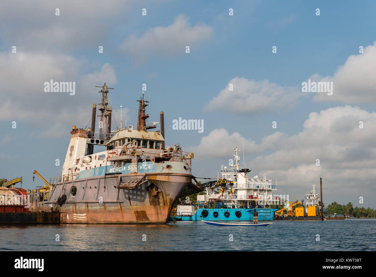 Old fishing trawler and the ferry boat across the Volta River in repair ...