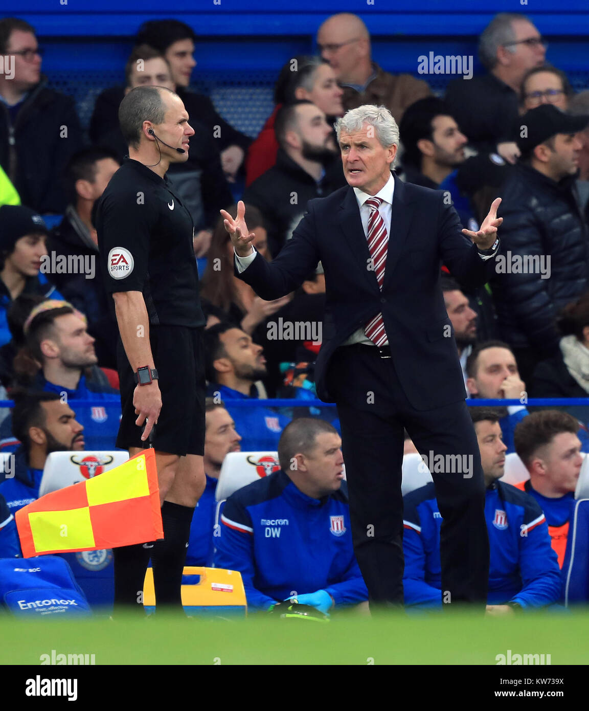 Stoke City manager Mark Hughes gestures to the assistant referee during ...