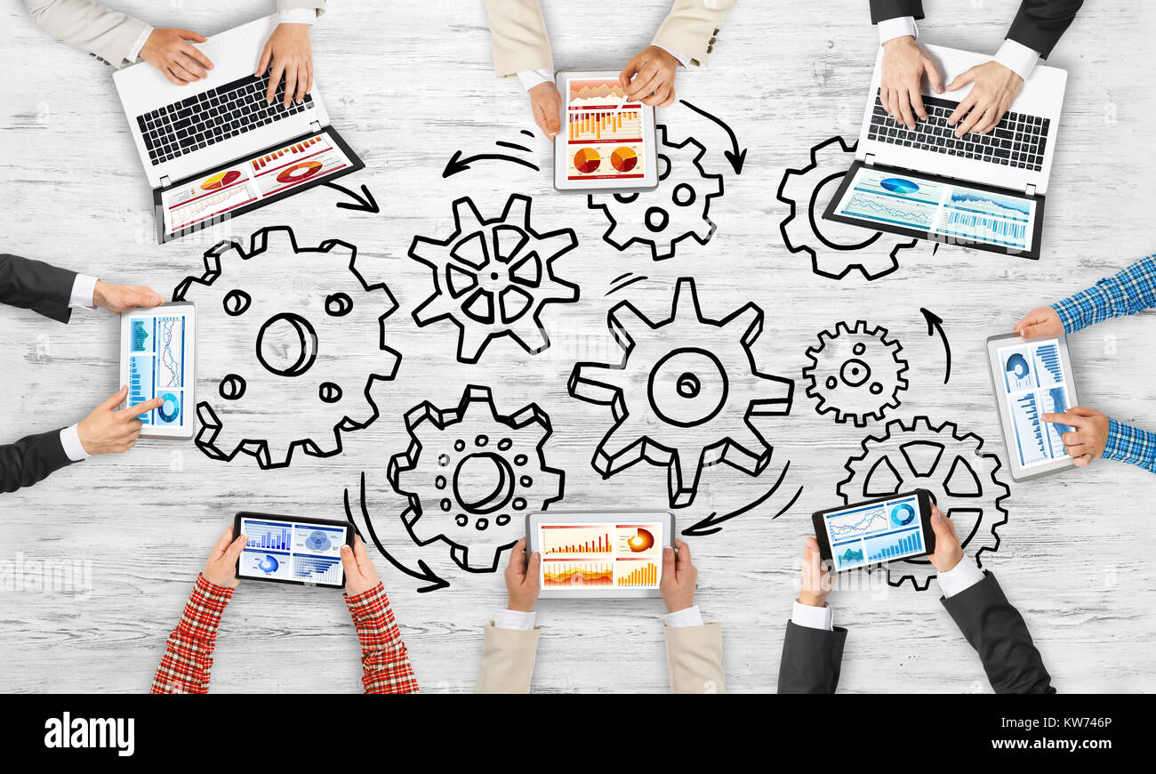 Group of people with devices in hands working together as symbol of ...