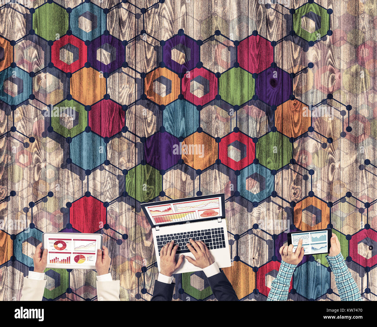 Group of three people with devices in hands working together as symbol ...