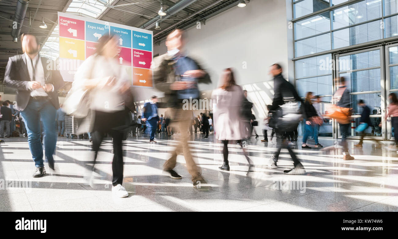 crowd of anonymous blurred business rushing Stock Photo - Alamy