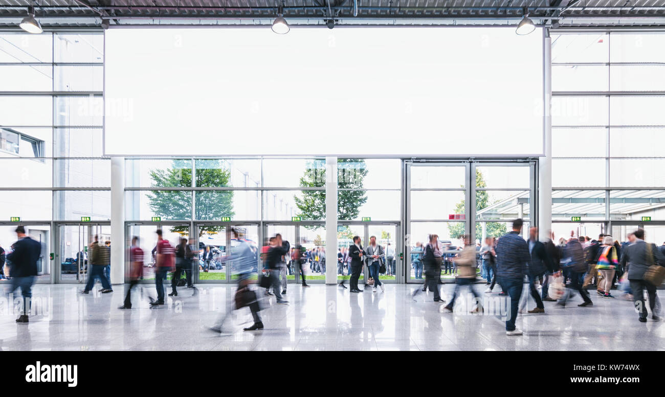 Anonymous Crowd of business people walking at a trade fair - concept ...
