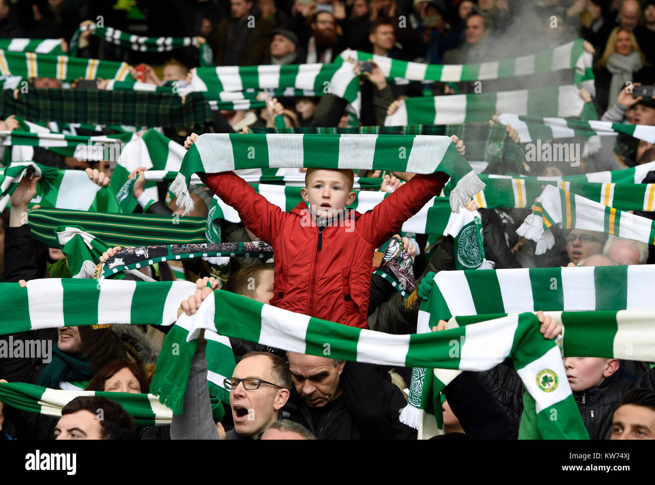 A young Celtic fan holds up his scarf during the Scottish Premiership ...