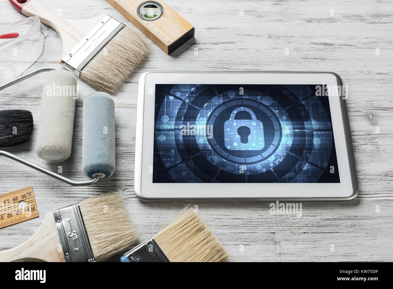 Tablet pc with security concept on screen and industrial tools around ...