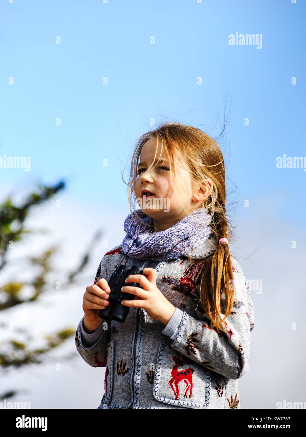 Cute little girl investigating Alps mountains using binocular ...