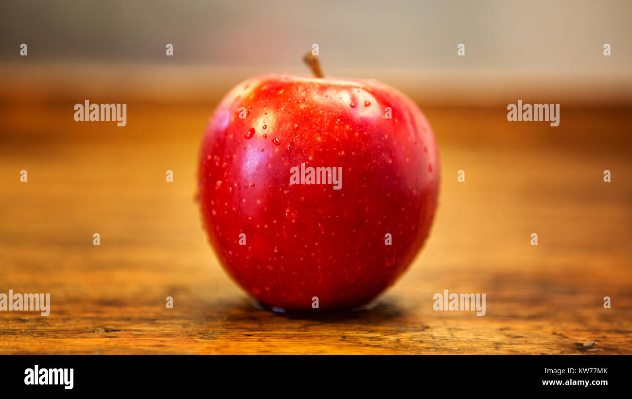 close up of red wet apple on rustic wooden table Stock Photo - Alamy