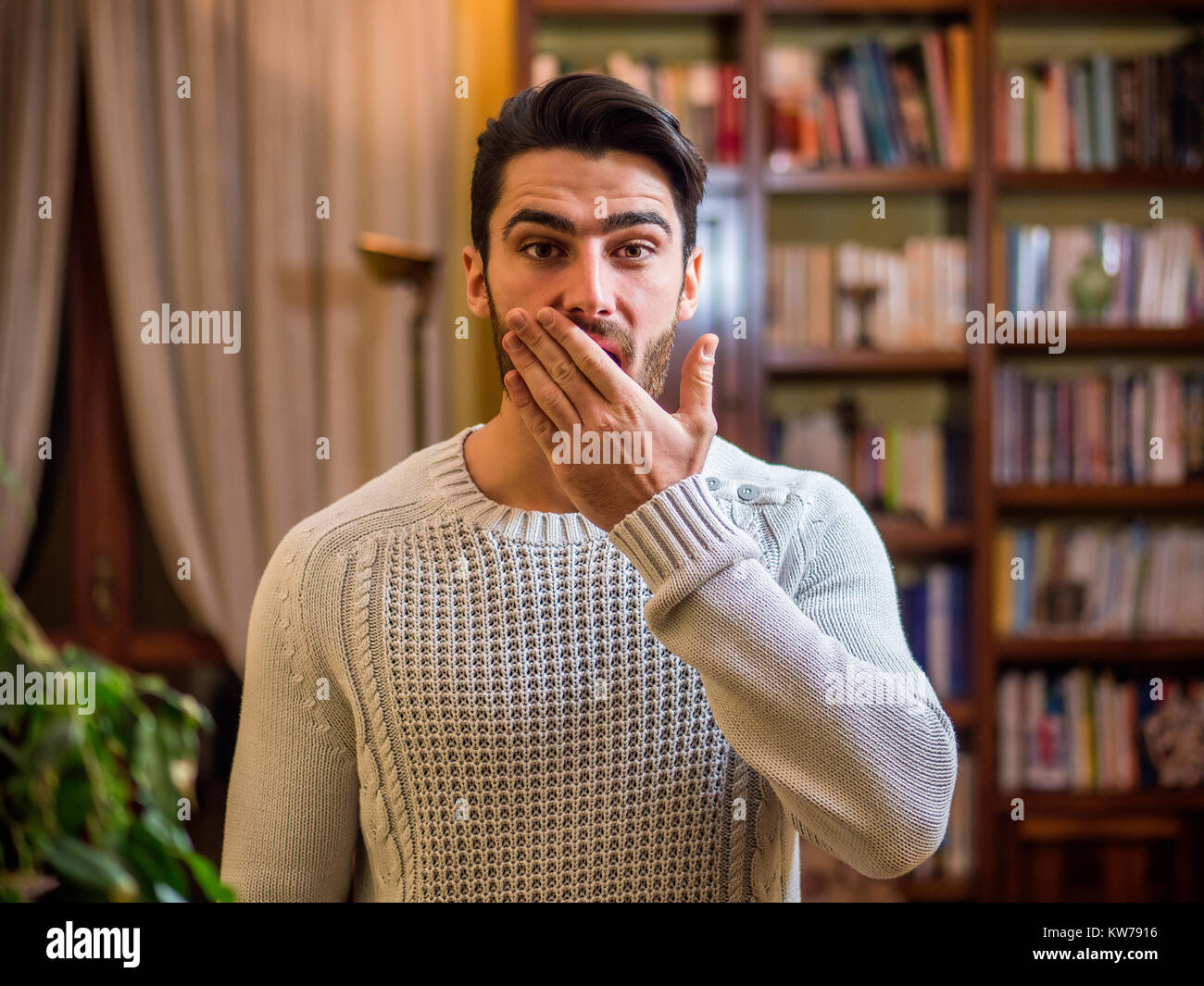 Surprised, happy handsome young man Stock Photo - Alamy