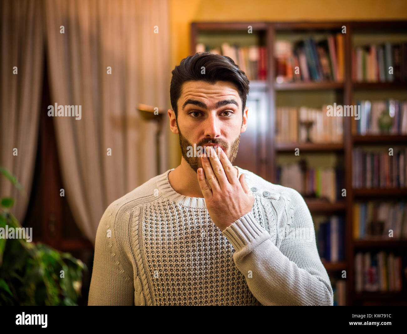 Surprised, happy handsome young man Stock Photo - Alamy