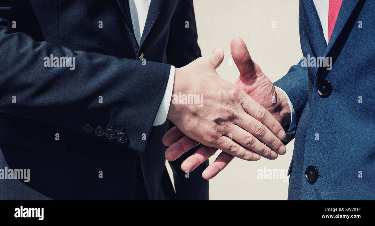 two businessman handshaking process Stock Photo - Alamy