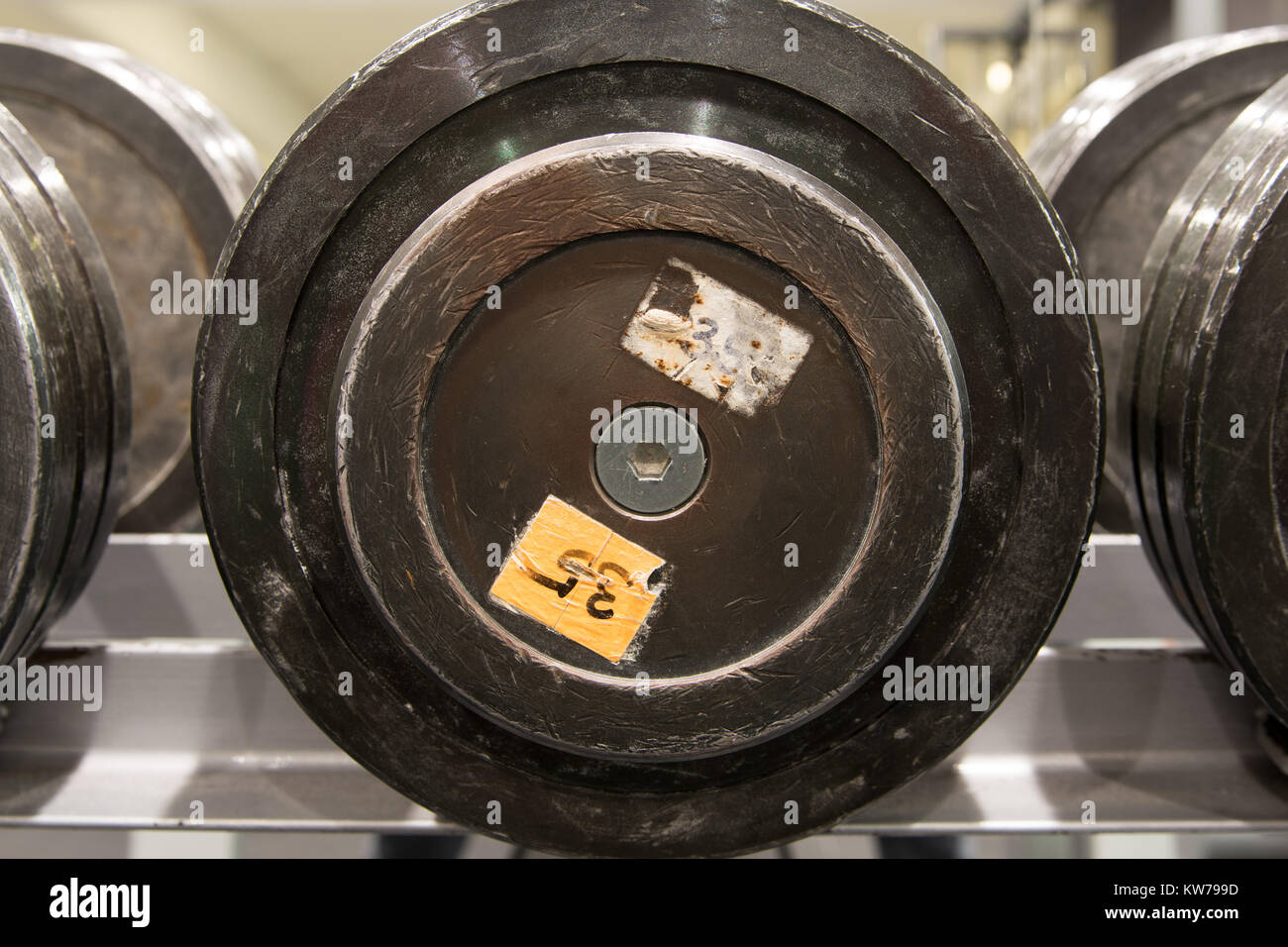 Old and used metal dumbbell on a rack in a gym. Fitness equipment Stock ...