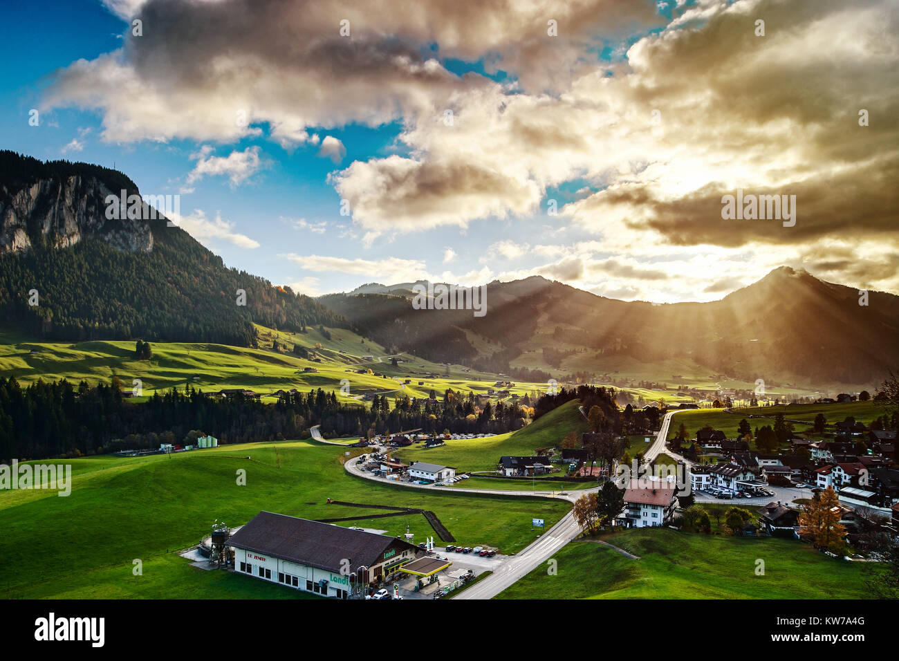 Sun beams lighting through the clouds and falling down to the little ...