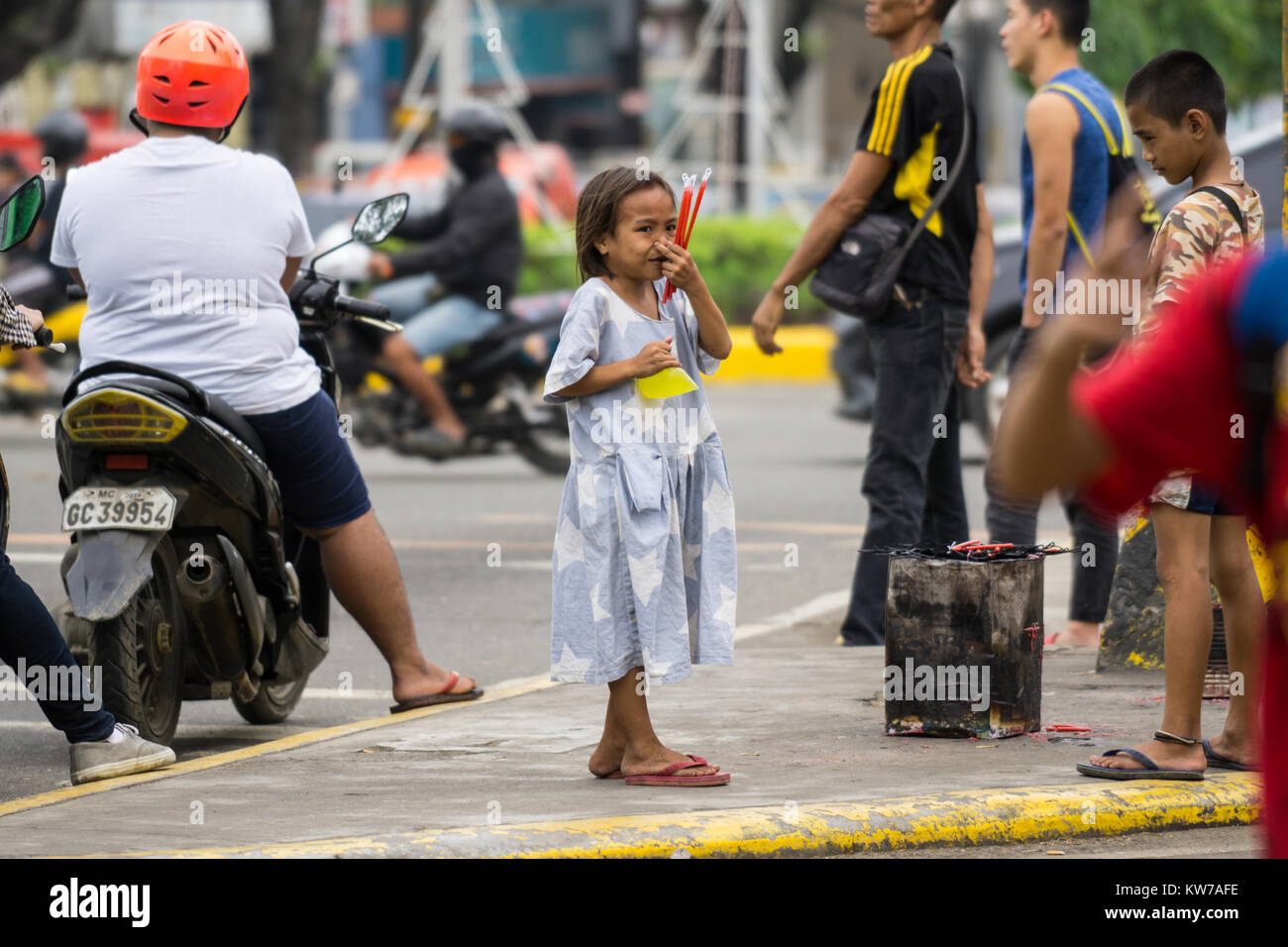 Young Filipino children selling candles at a busy junction,Cebu City ...