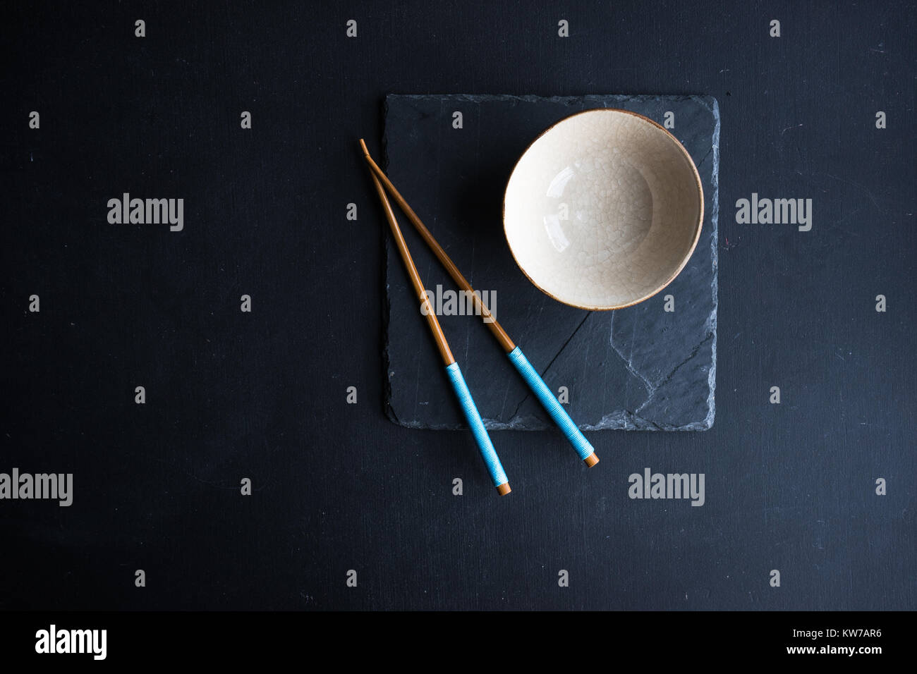 Rustic table set with chopsticks for festive dinner in asian style ...