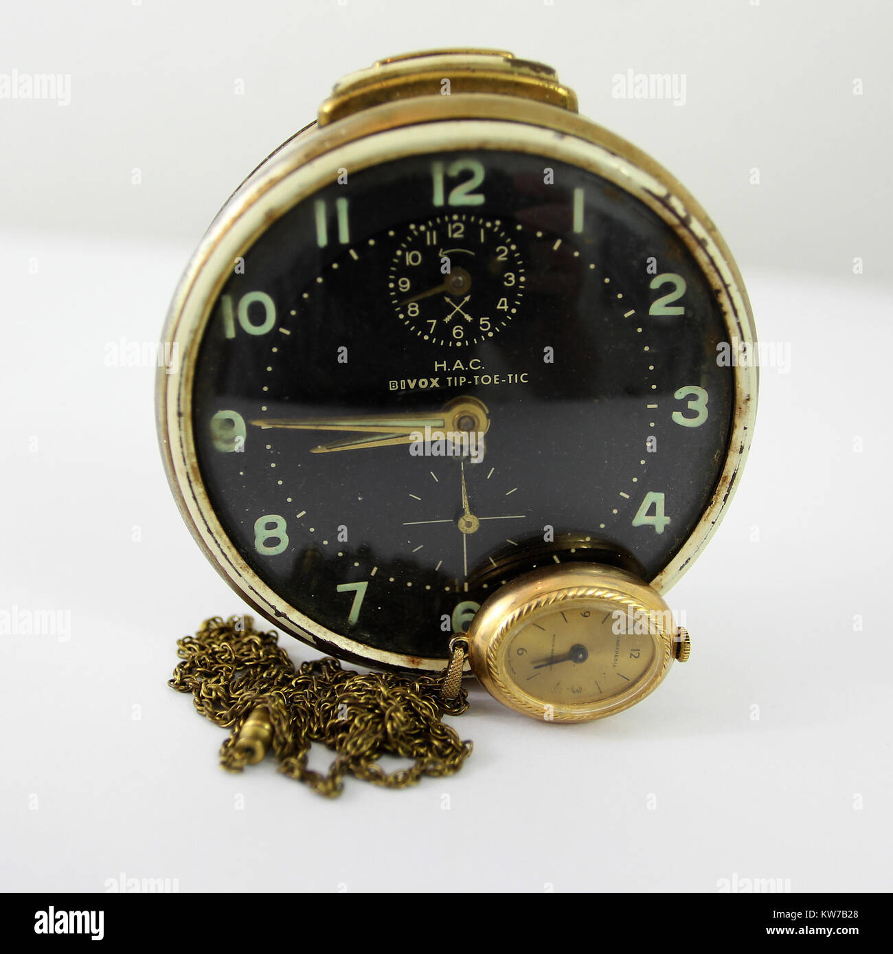 Antique brass clock and gold plated pendant watch on chain Stock Photo ...