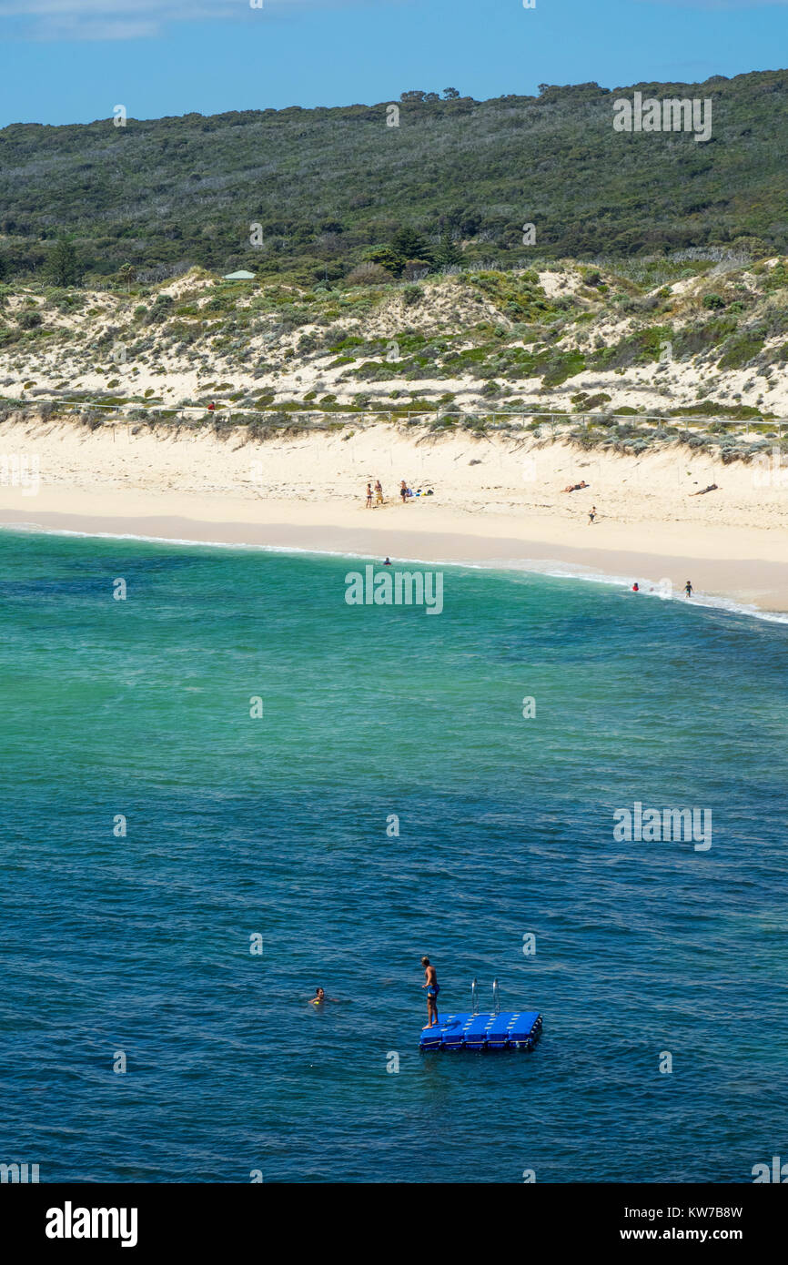 Two boys swimming and playing on a pontoon at Gnarabup Beach, Margaret ...