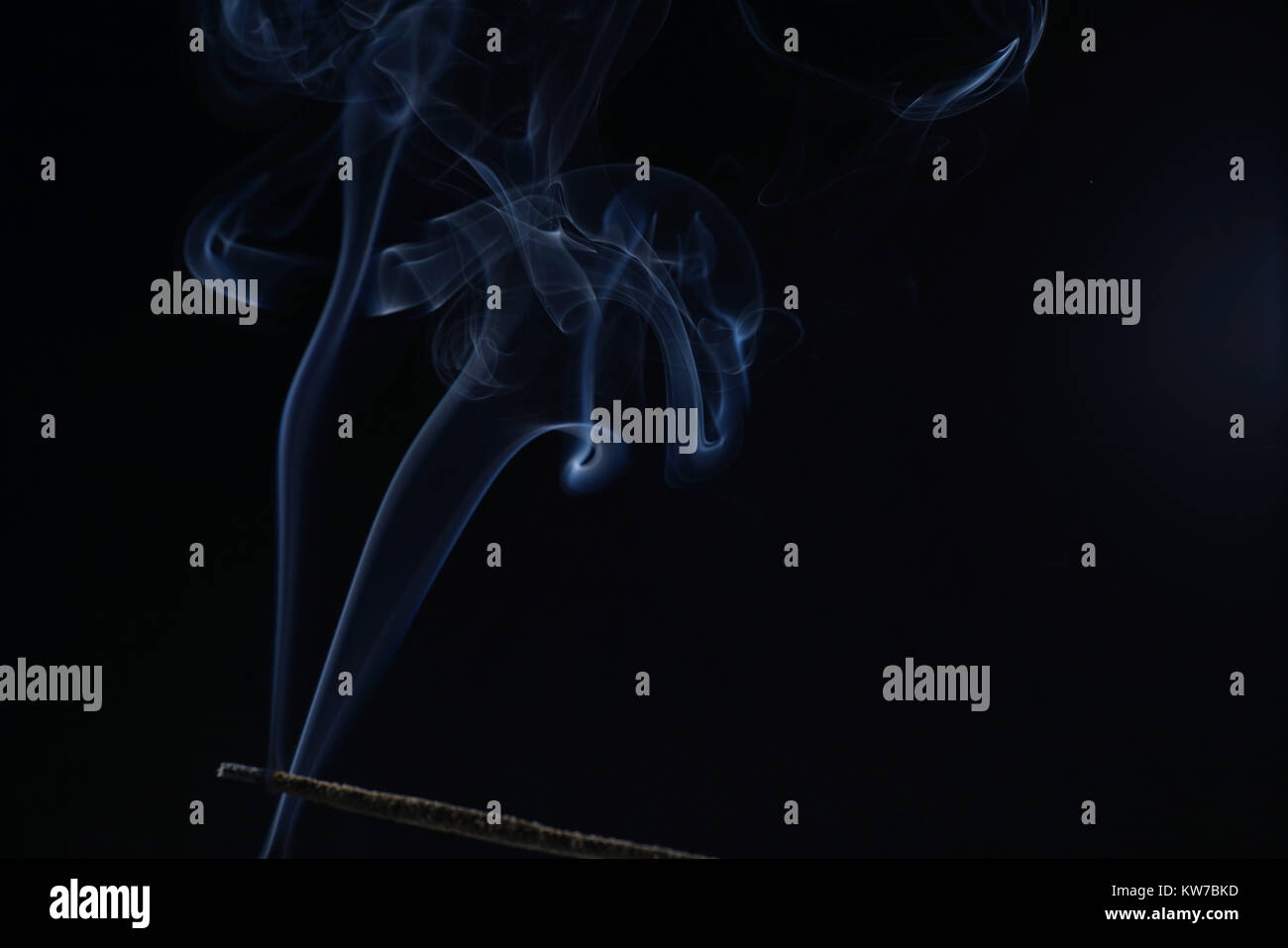 Smoke photographed by an incense stick in the studio Stock Photo - Alamy