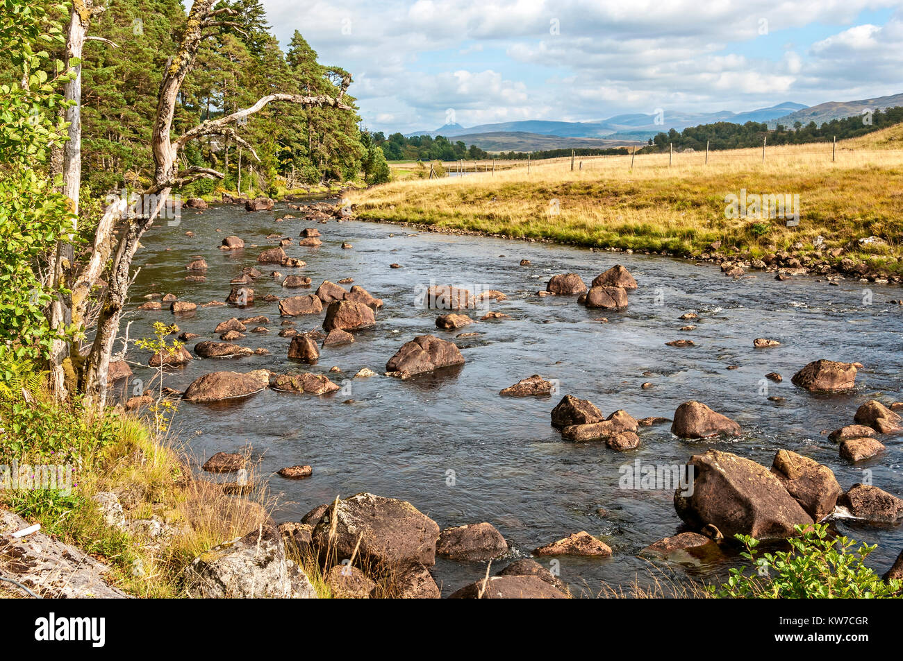 The crystal clear water of the River Tummel leaves eddies behind as it ...