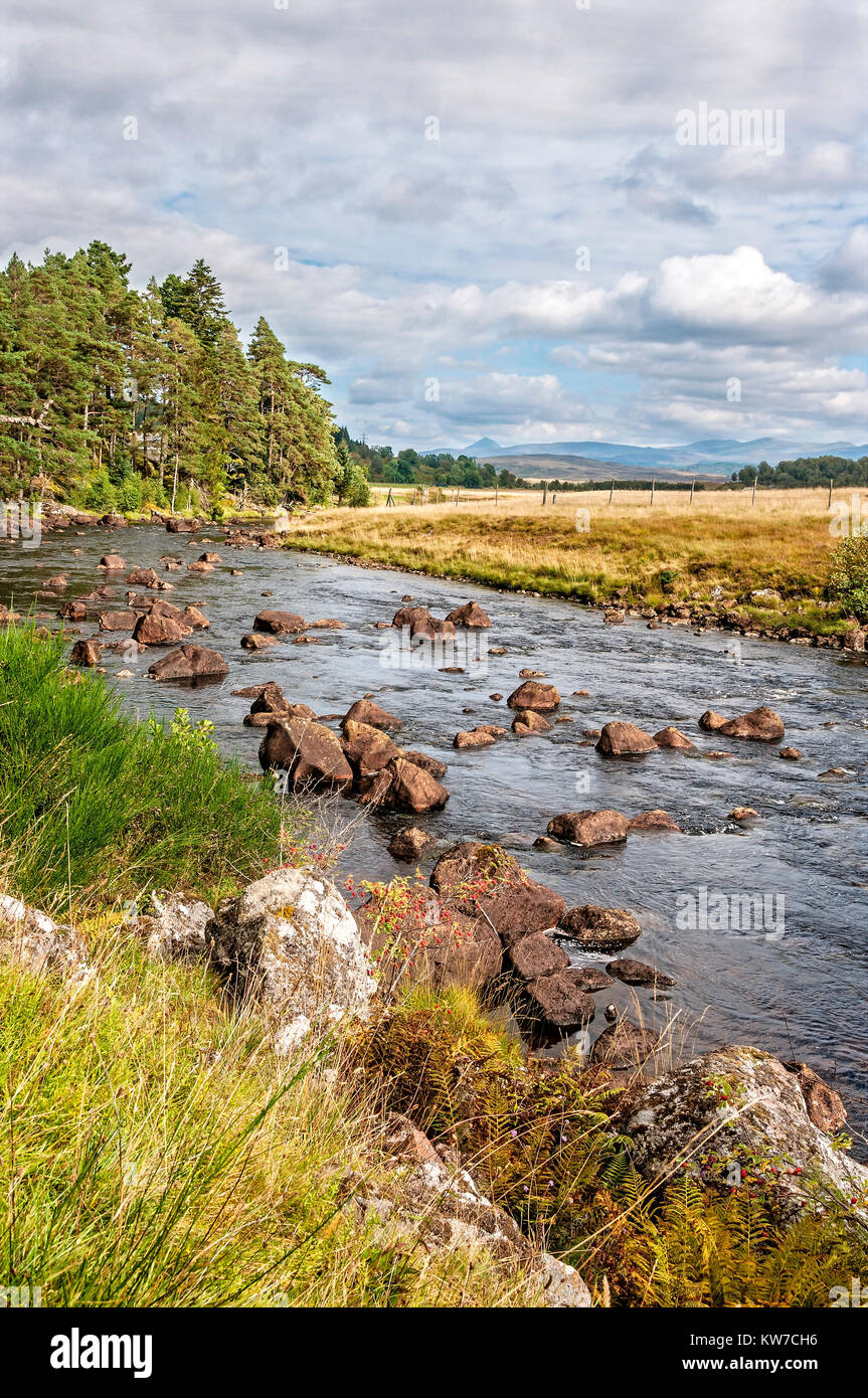 The crystal clear water of the River Tummel leaves eddies behind as it ...