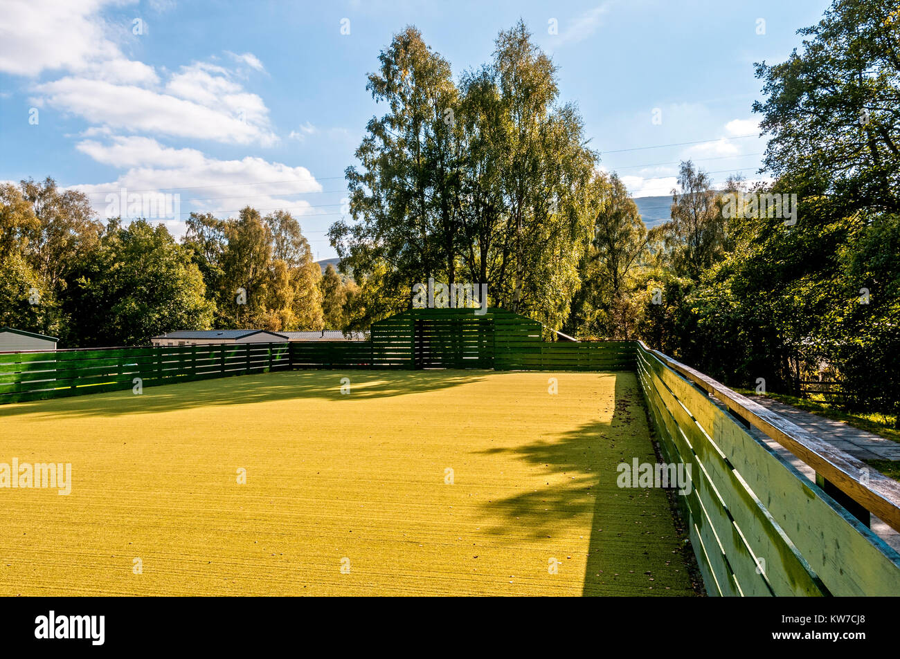 Strong Autumn sunshine reflects off the synthetic surface of the all ...