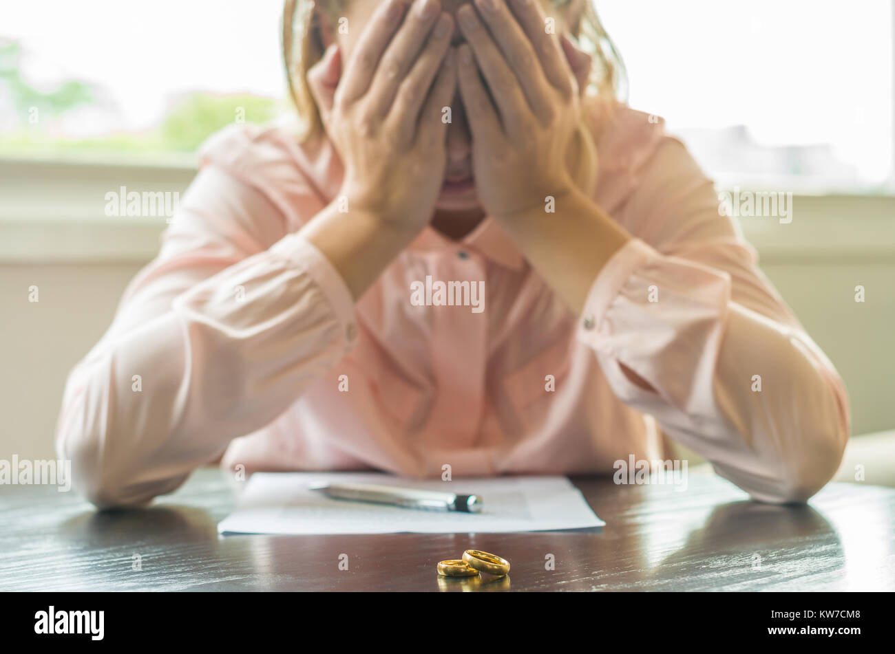 Great concept of divorce, end of relationship, sad young woman, signing ...