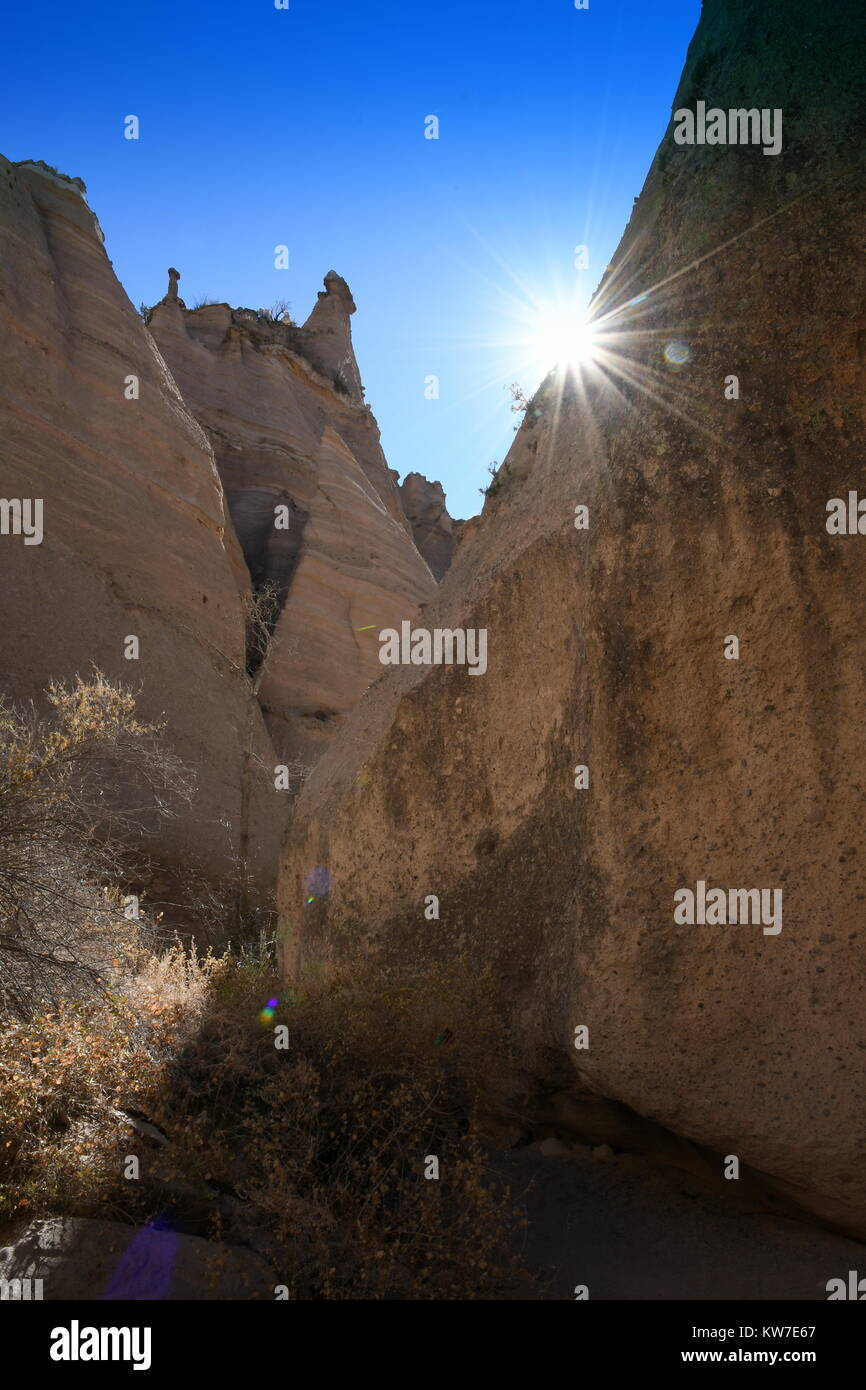 A sunburst accentuates the canyon walls of Tent Rock National Monument ...