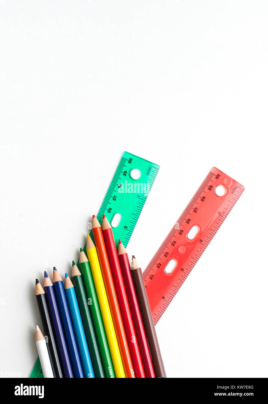 Colored pencils and rulers on white background Stock Photo - Alamy