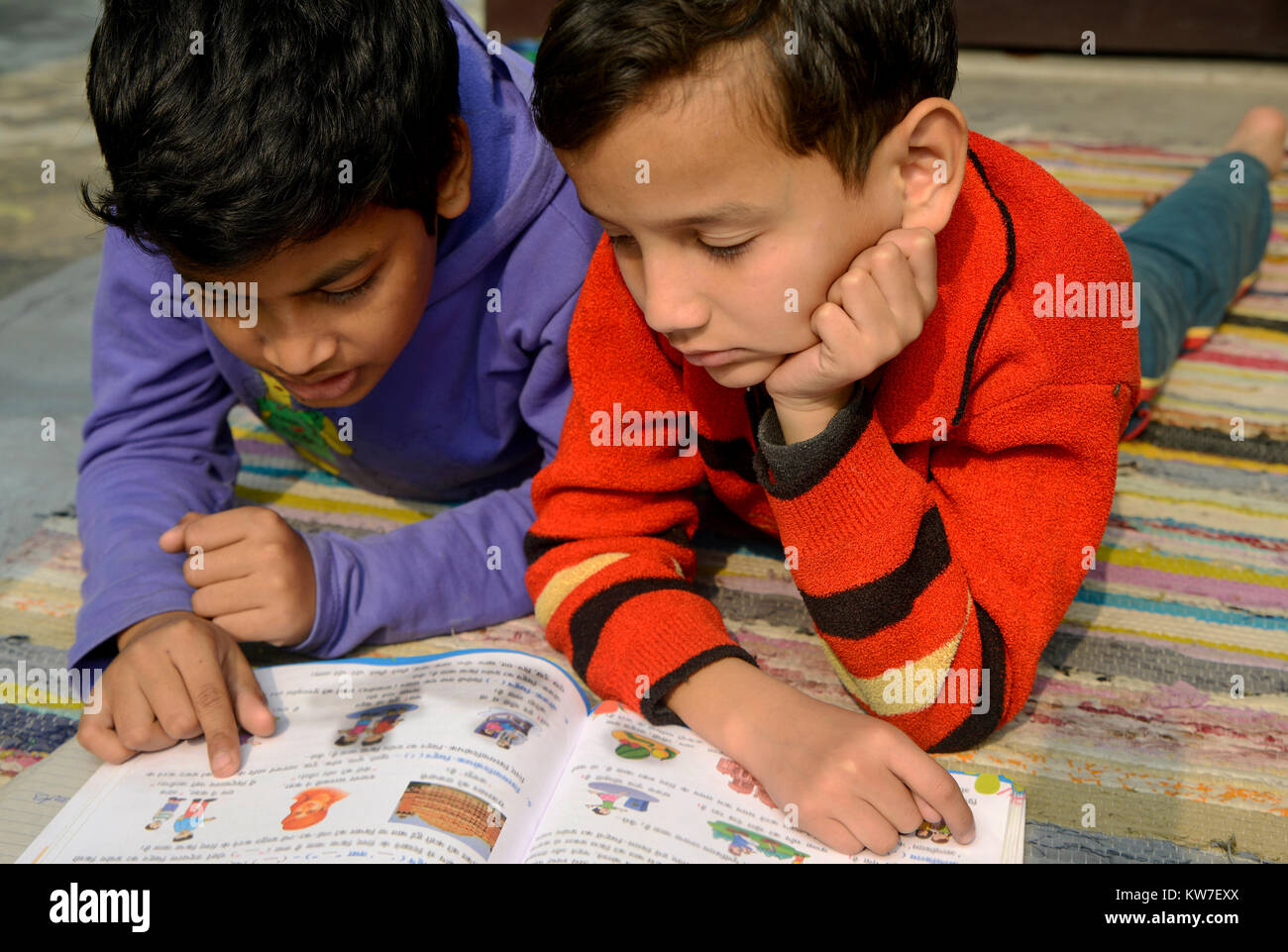 Little boys reading book Stock Photo - Alamy