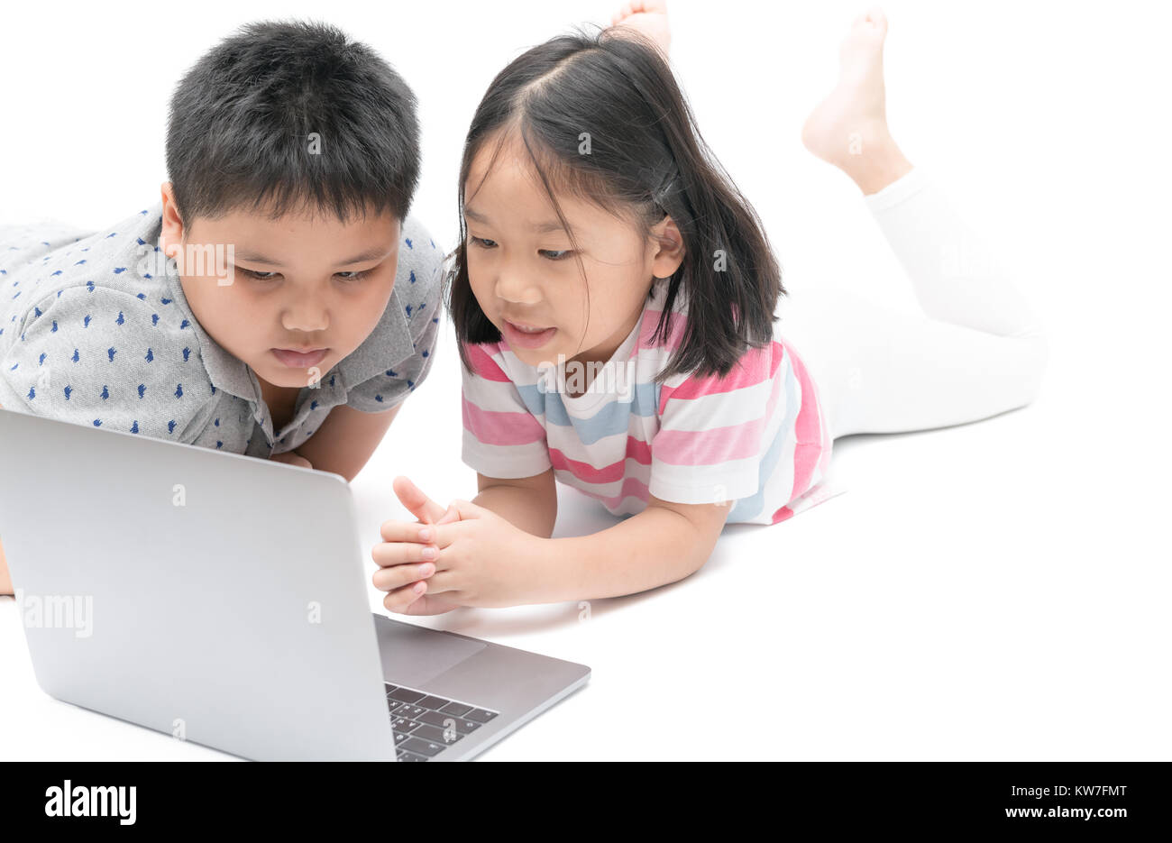 cute sister and young brother play laptop isolated on white background ...