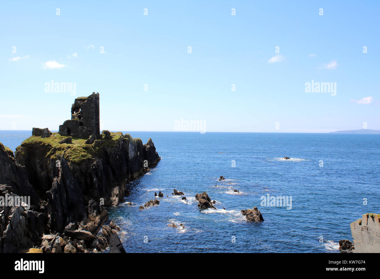 Old Irish Castle balancing on the cliffs of the Coastline overlooking ...