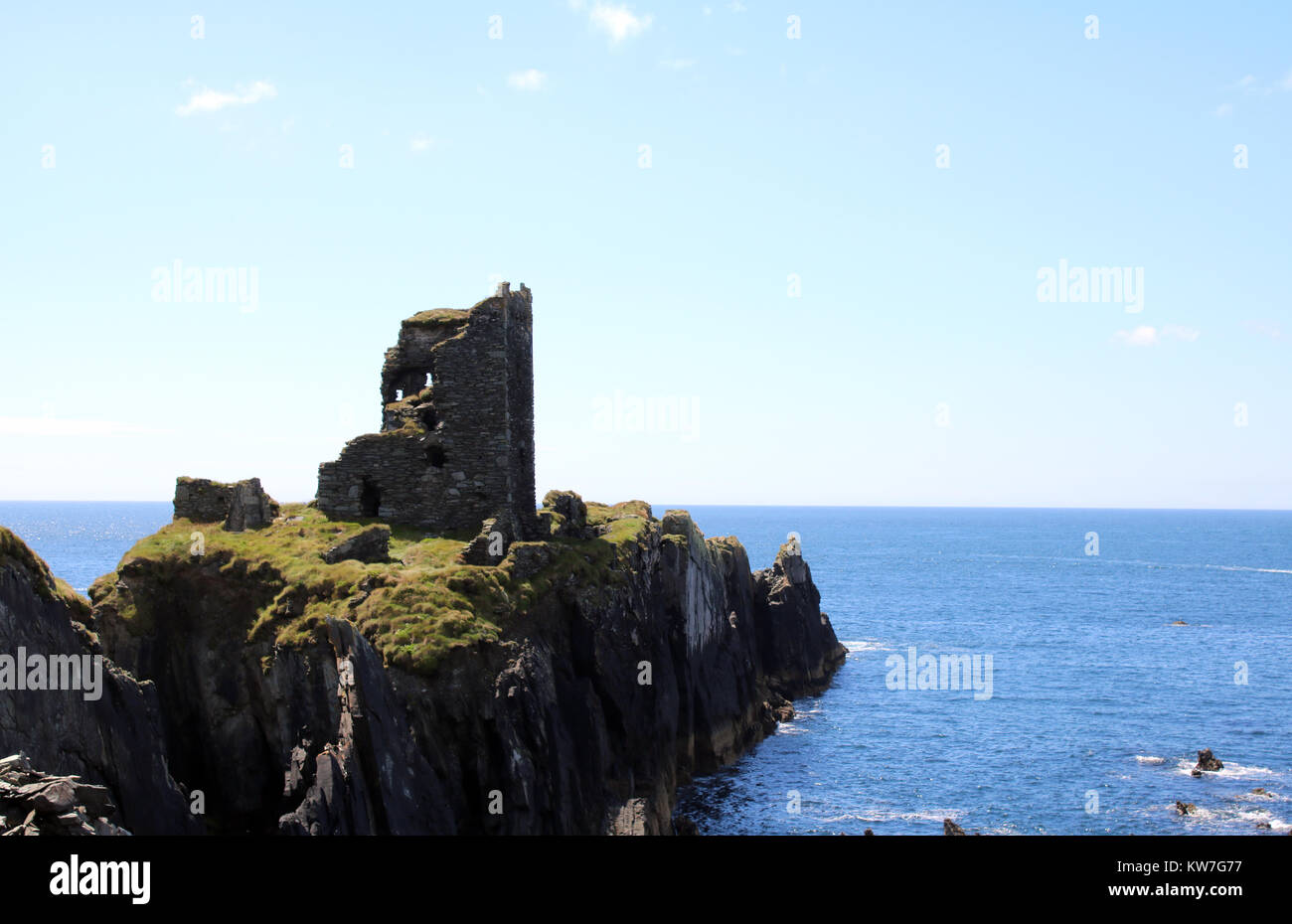 Old Irish Castle balancing on the cliffs of the Coastline overlooking ...