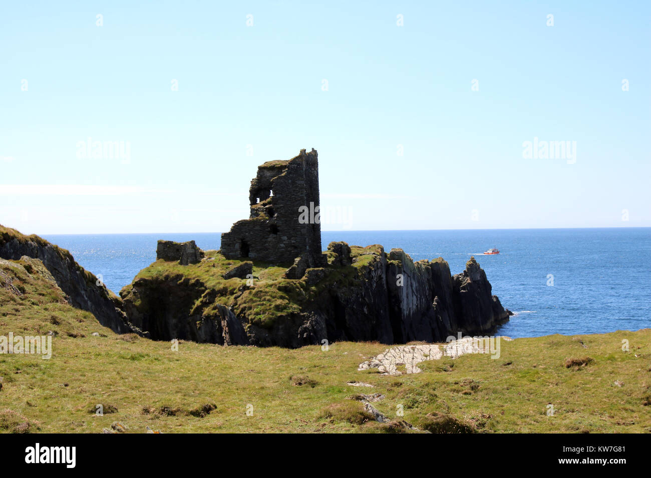 Old Irish Castle balancing on the cliffs of the Coastline overlooking ...