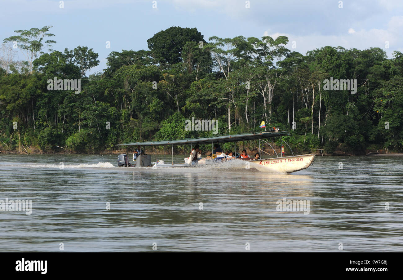 A fast ferry or water bus speeds along the Napo River near Coca or ...