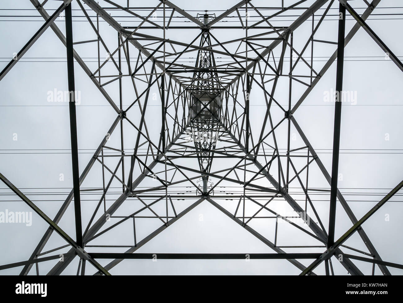 Abstract pattern looking directly up underneath high electricity pylon ...