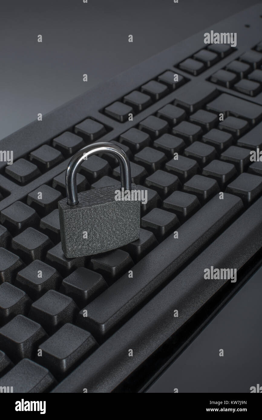Padlock resting on blank black Qwerty keyboard - for concept of secure ...