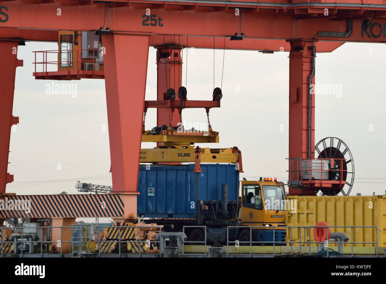 Gantry crane adjacent to river loading containers onto trucks Stock ...