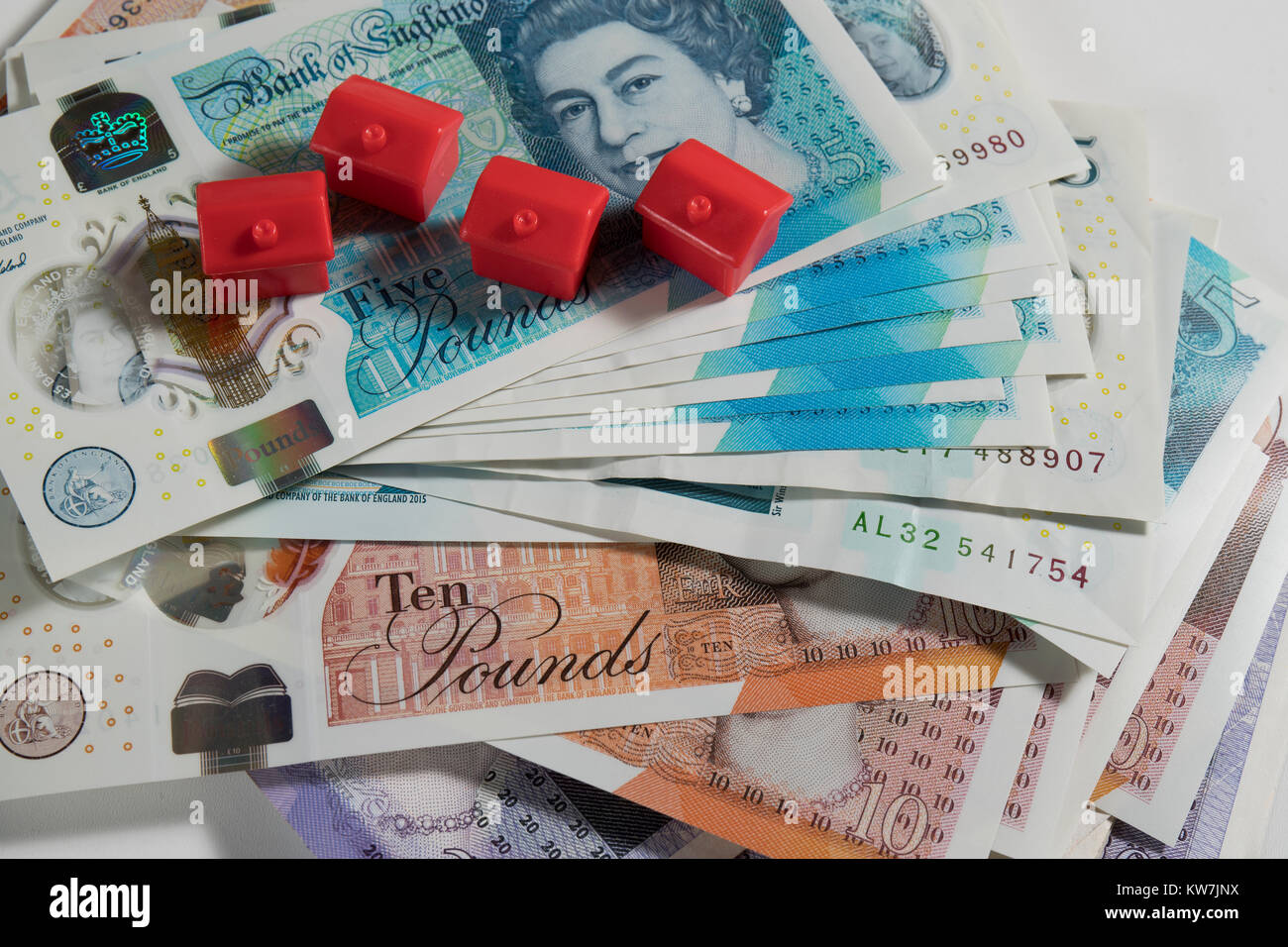 5, 10 and 20 Pound notes randomly arranged with red monopoly hotels ...