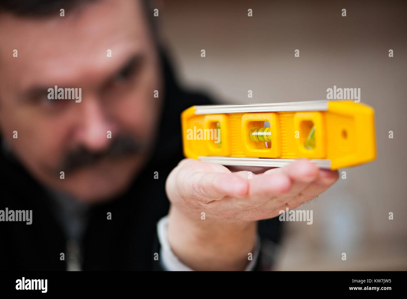 Architect holding a spirit level Stock Photo - Alamy