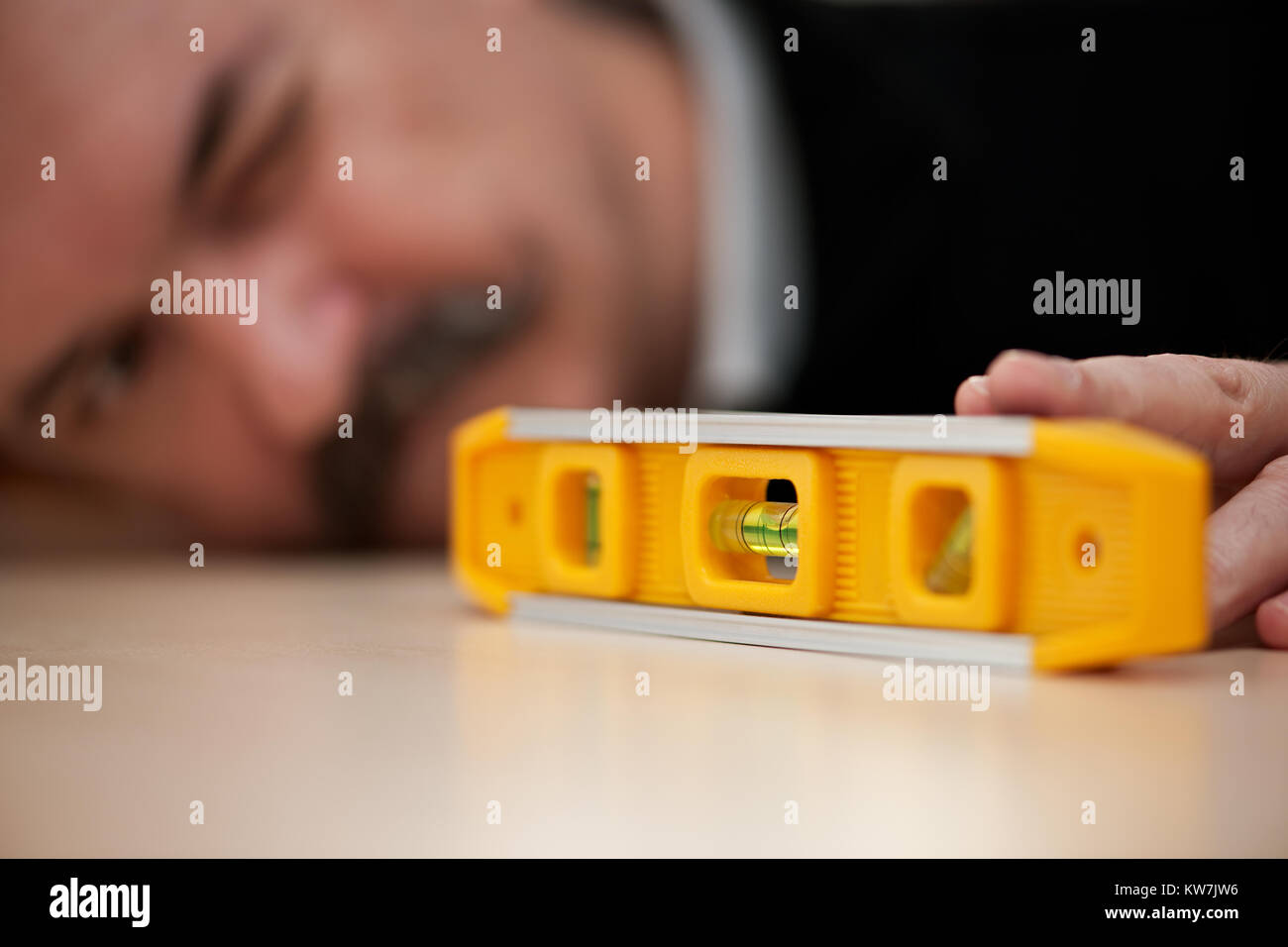 Architect holding a spirit level Stock Photo - Alamy