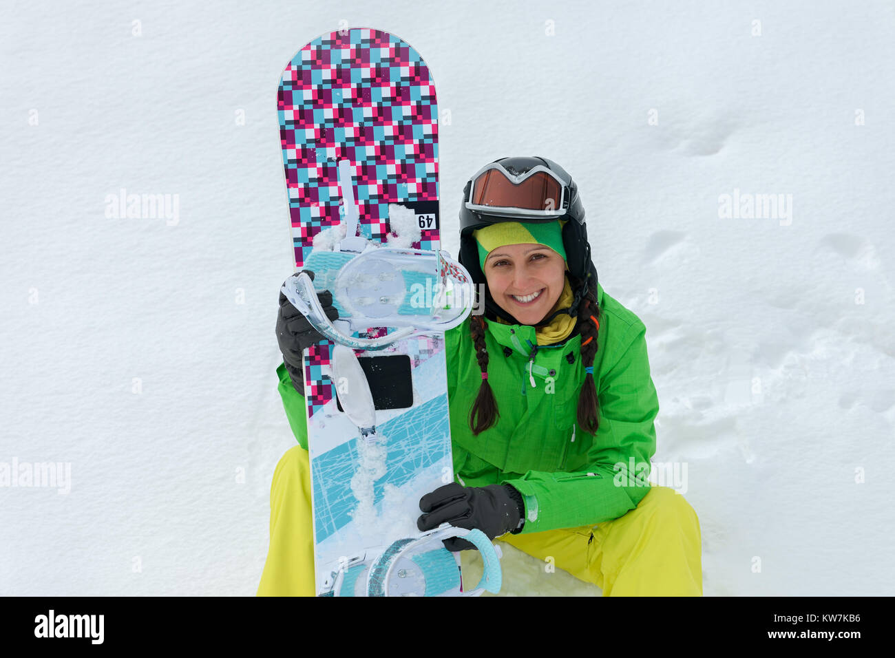 Pretty young woman on the snowboard Stock Photo - Alamy