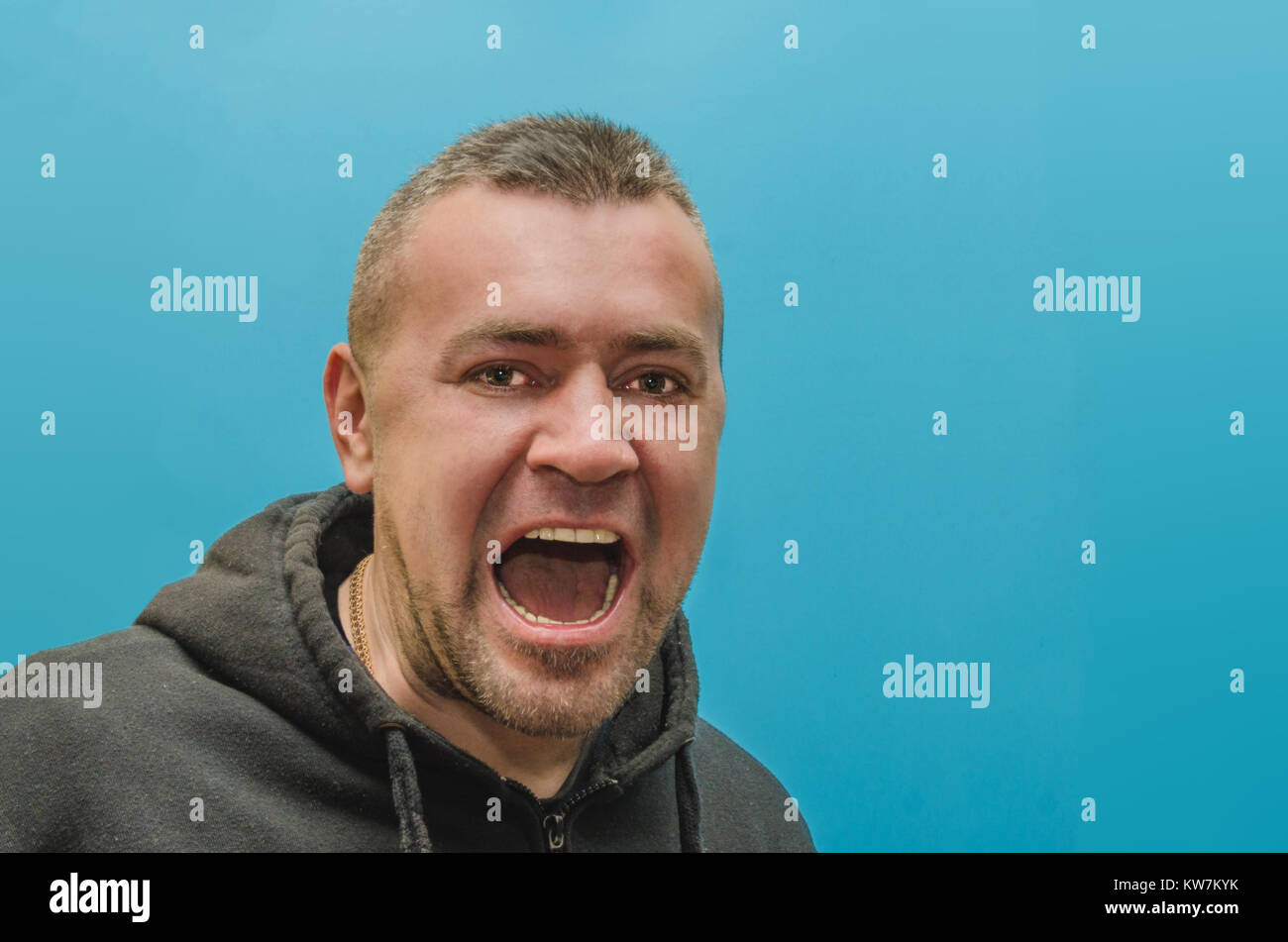 screaming man looking at the camera Stock Photo - Alamy