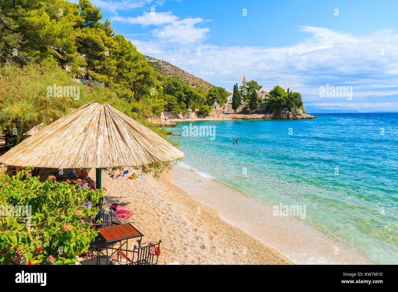 View of beautiful pebble beach with turquoise water and view of ...