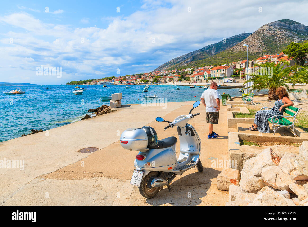 BOL TOWN, BRAC ISLAND - SEP 8, 2017: Couple of tourists and scooter on ...