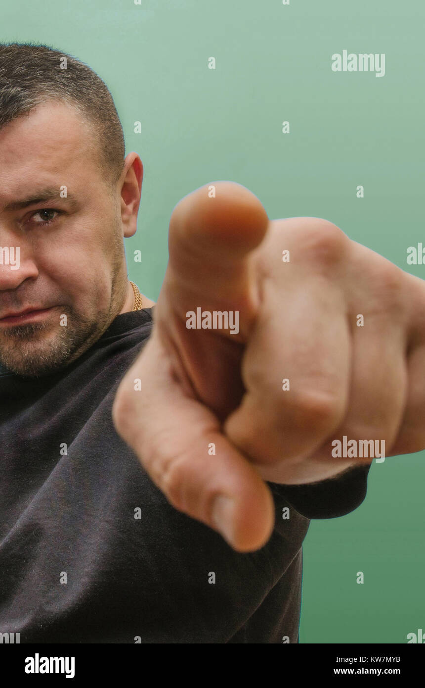 sad man is pointing his finger at the camera on green and white Stock ...