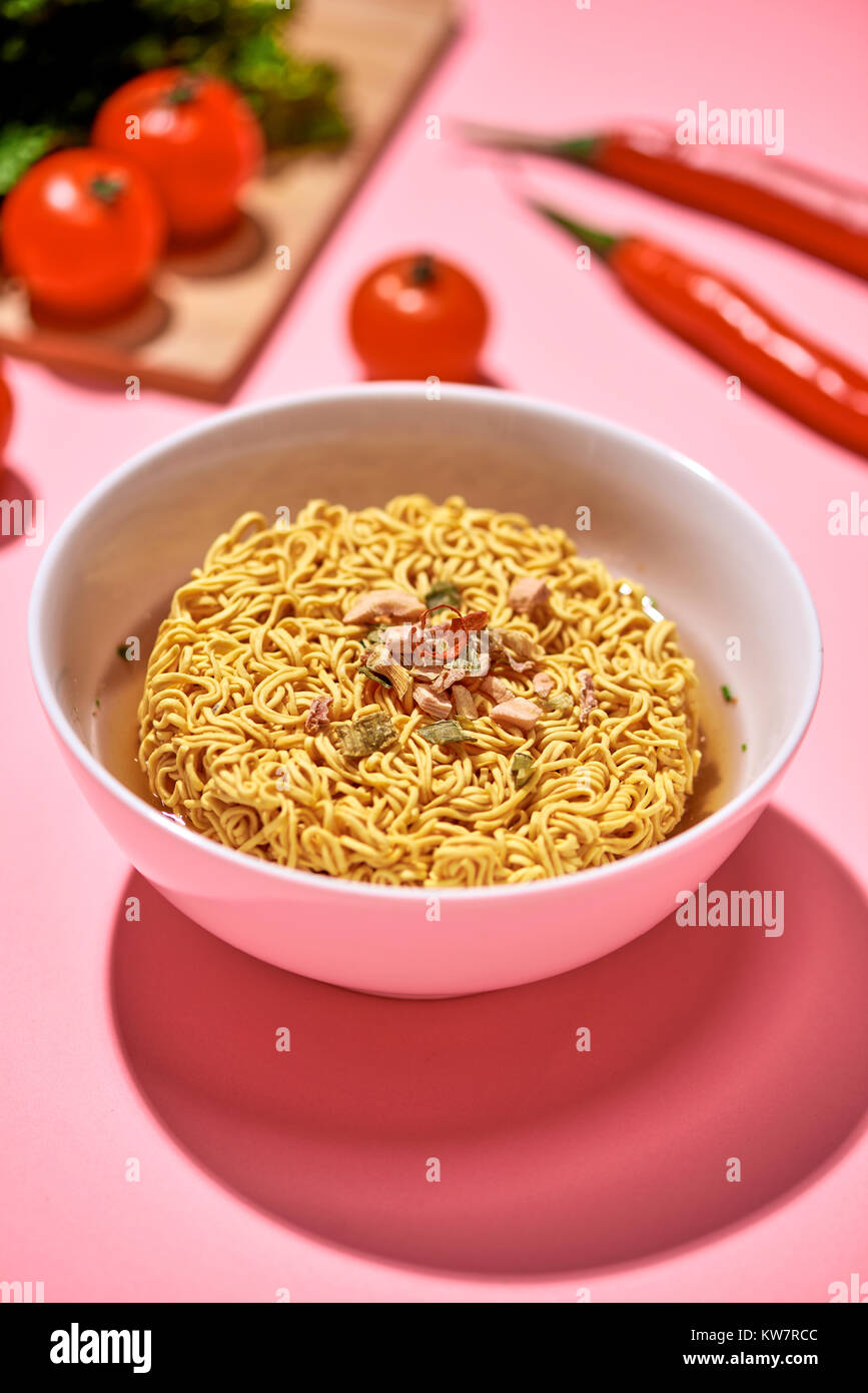 A Bowl of instant noodles on pink background Stock Photo - Alamy