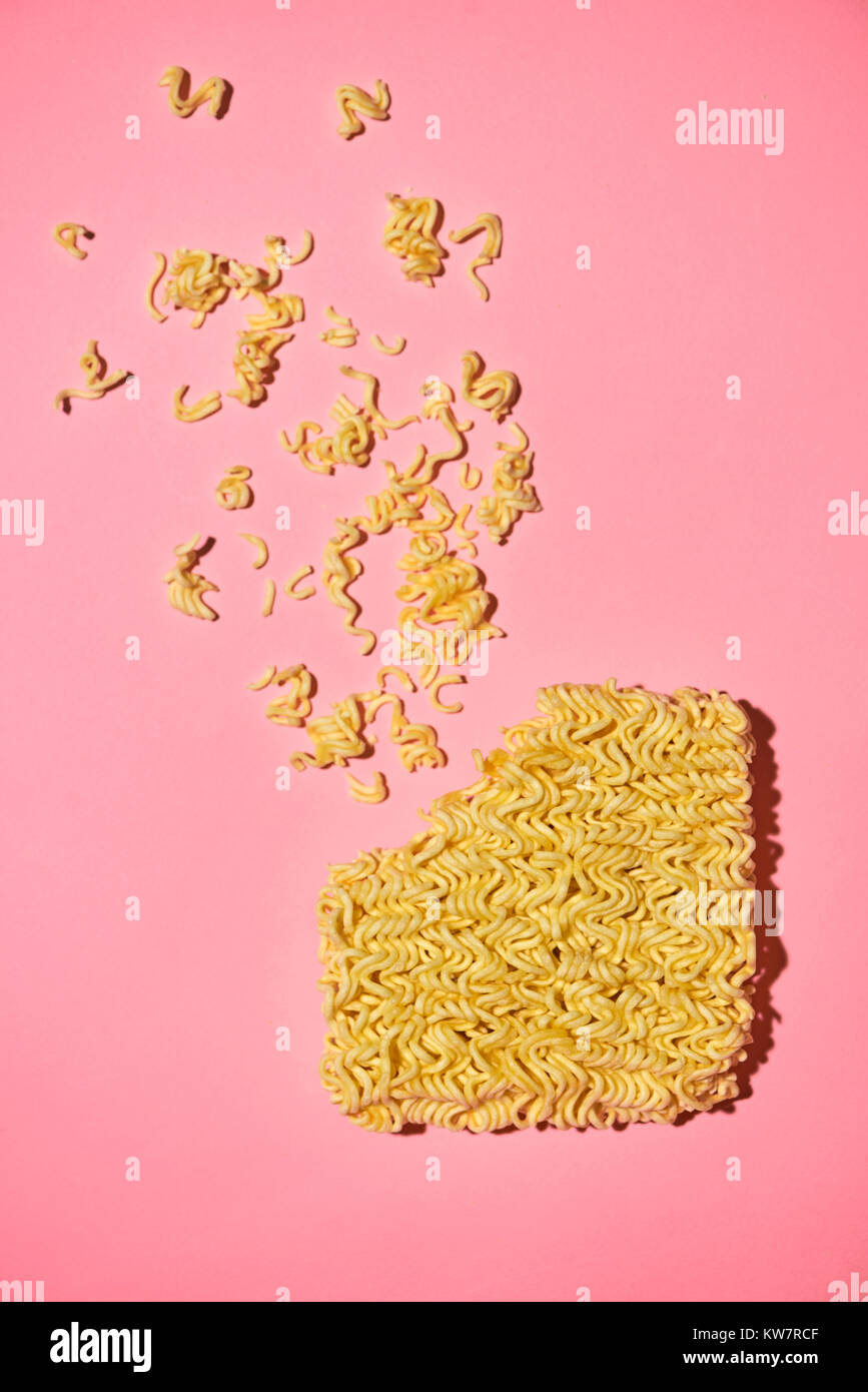 Cracked Instant noodles isolated on a pink background Stock Photo - Alamy