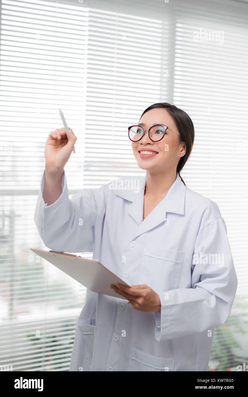 Doctor asian female writing something with marker Stock Photo - Alamy