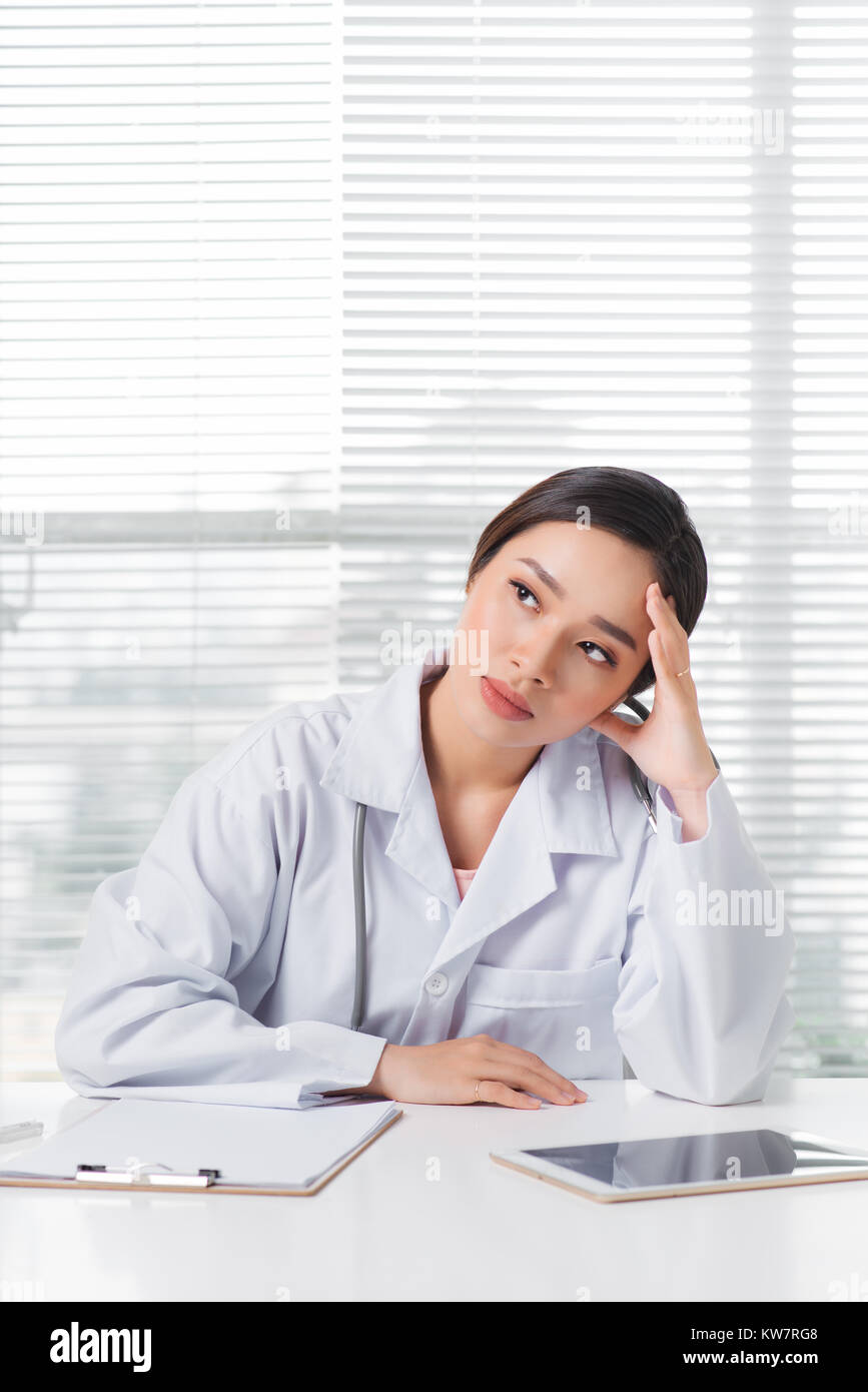 Portrait of a happy thoughtful female doctor Stock Photo - Alamy